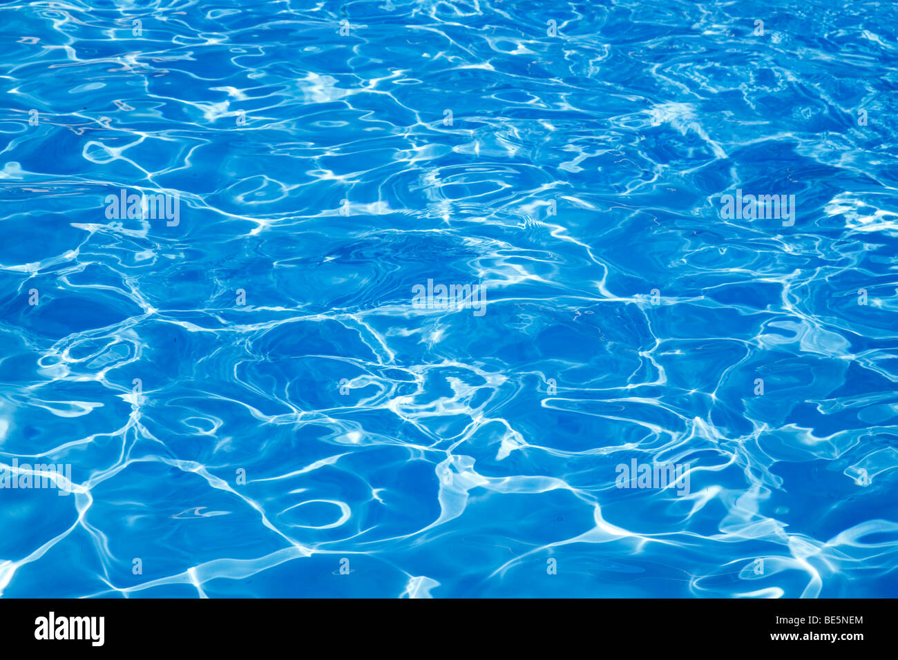 Blue water in the blue pool with light reflections in it Stock Photo ...