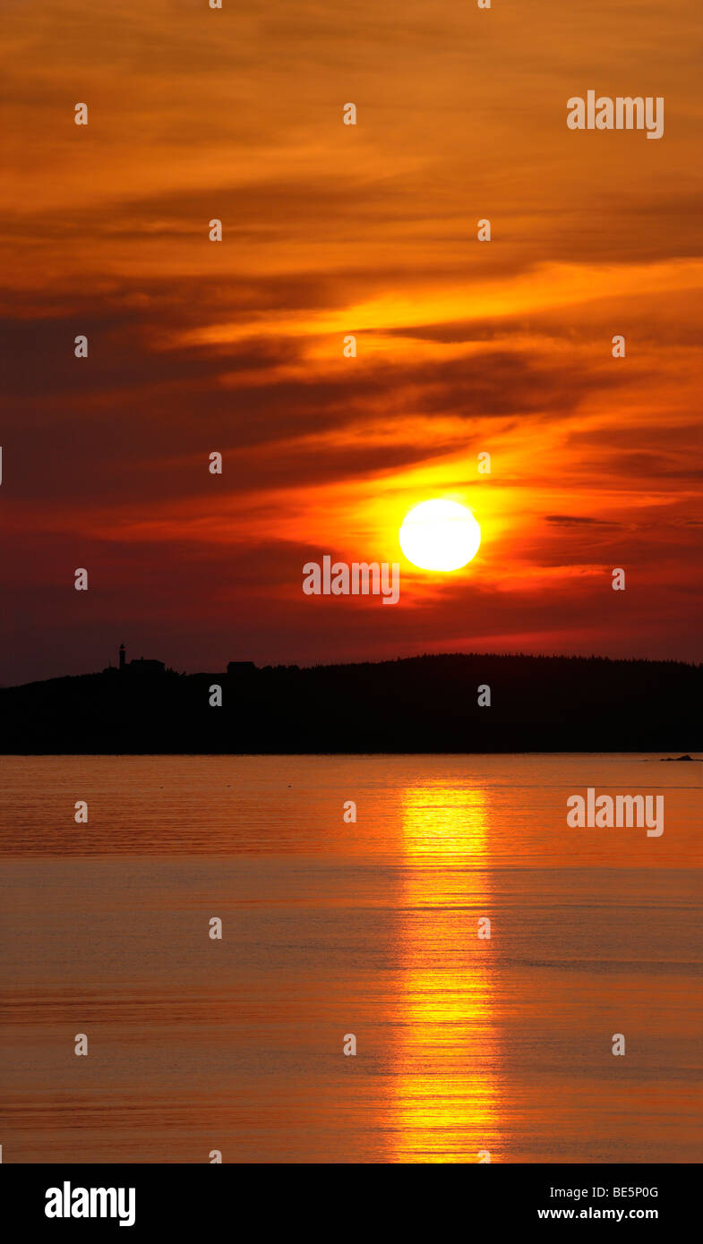Red ball sun sunset and reflection from Rocky Harbour Newfoundland with ...