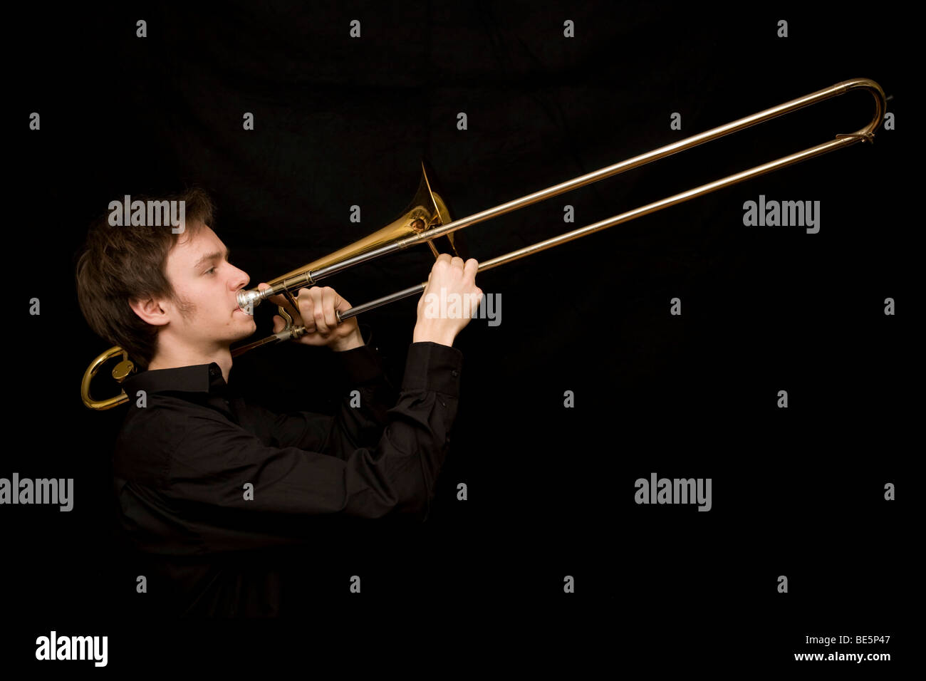 Young musician playing the trombone Stock Photo - Alamy