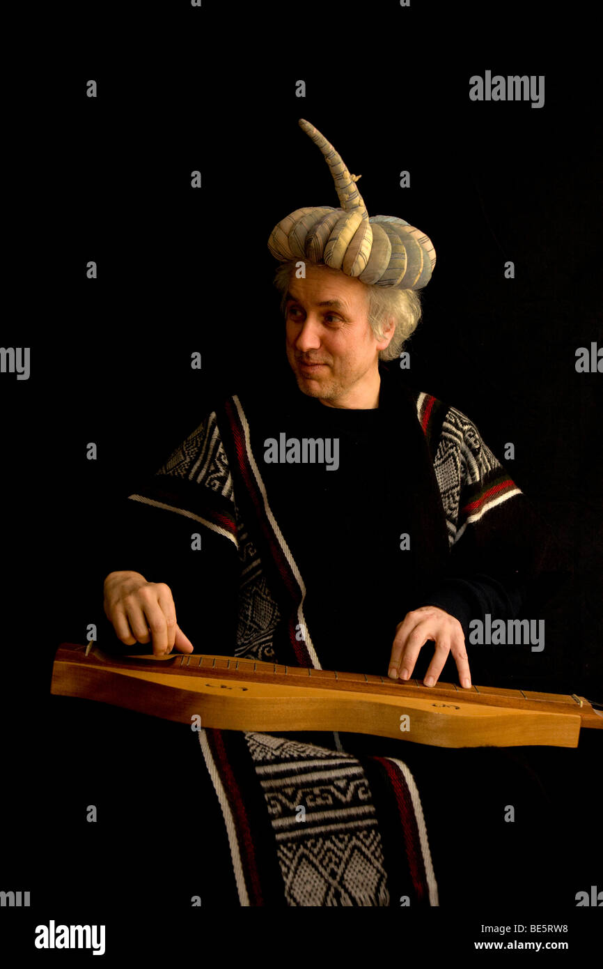 Musician in traditional costume playing the dulcimer Stock Photo - Alamy