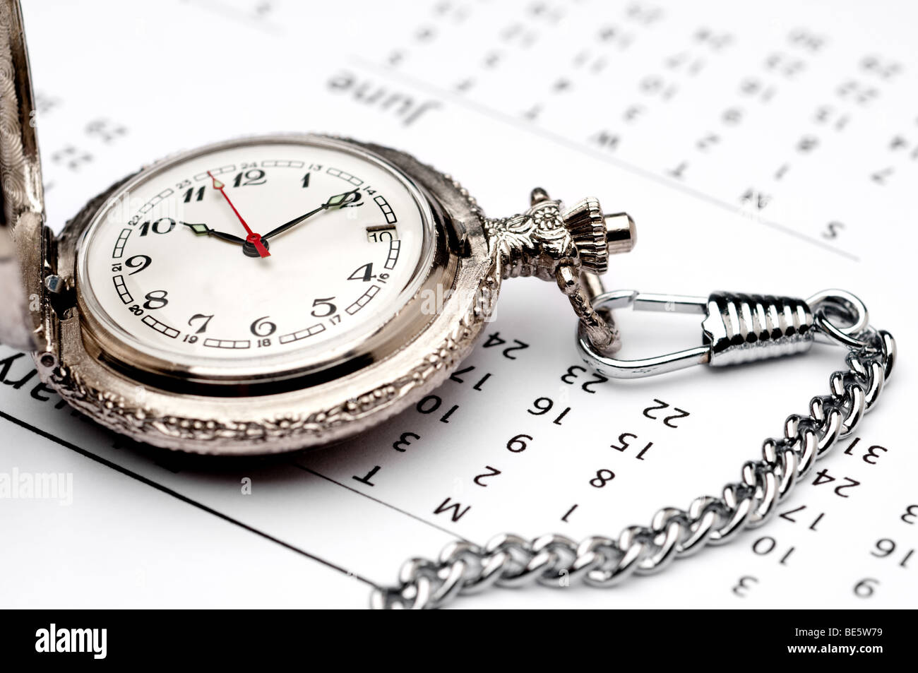 horizontal close up of a pocket watch on a calendar Stock Photo - Alamy