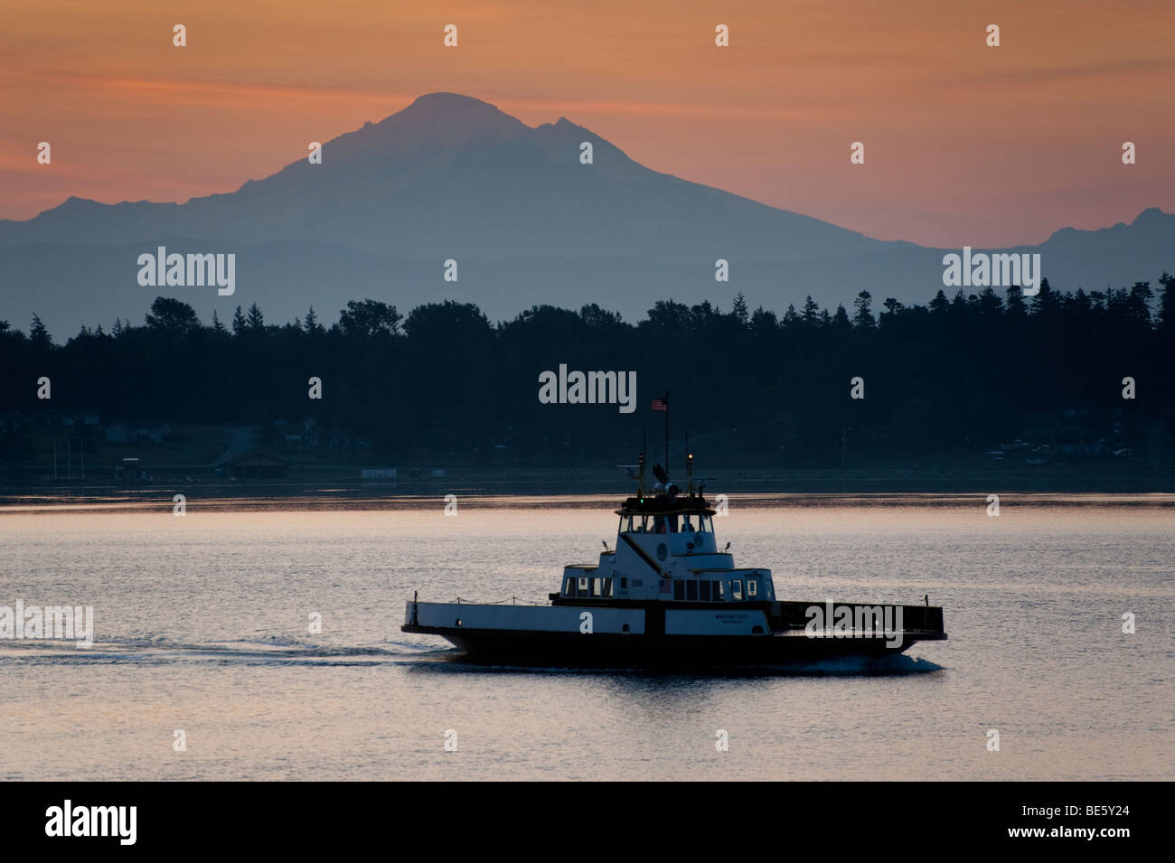 Sunrise over Mt. Baker, Washington and the Lummi Island Ferry. The ...