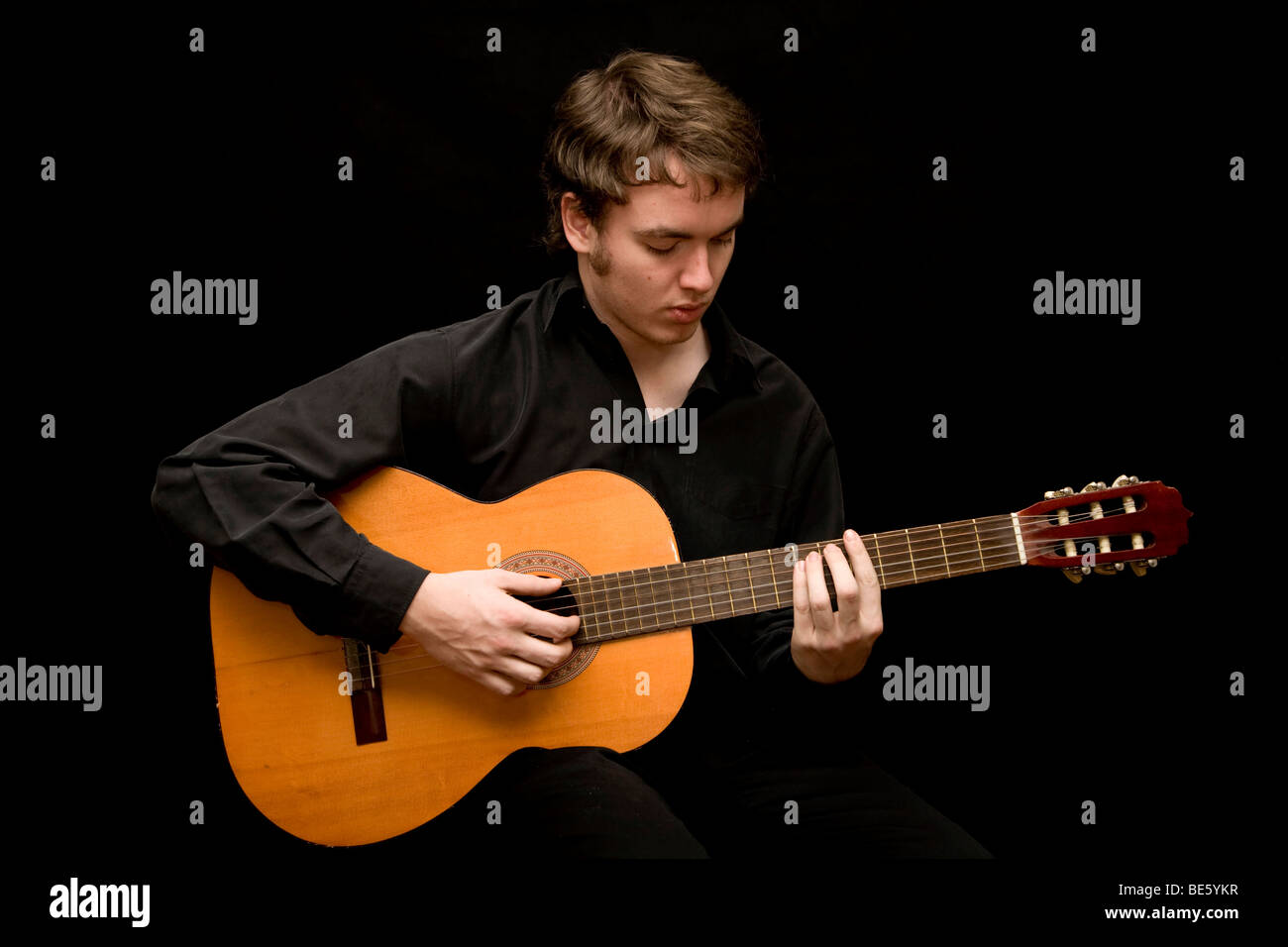 Young musician playing a guitar Stock Photo - Alamy