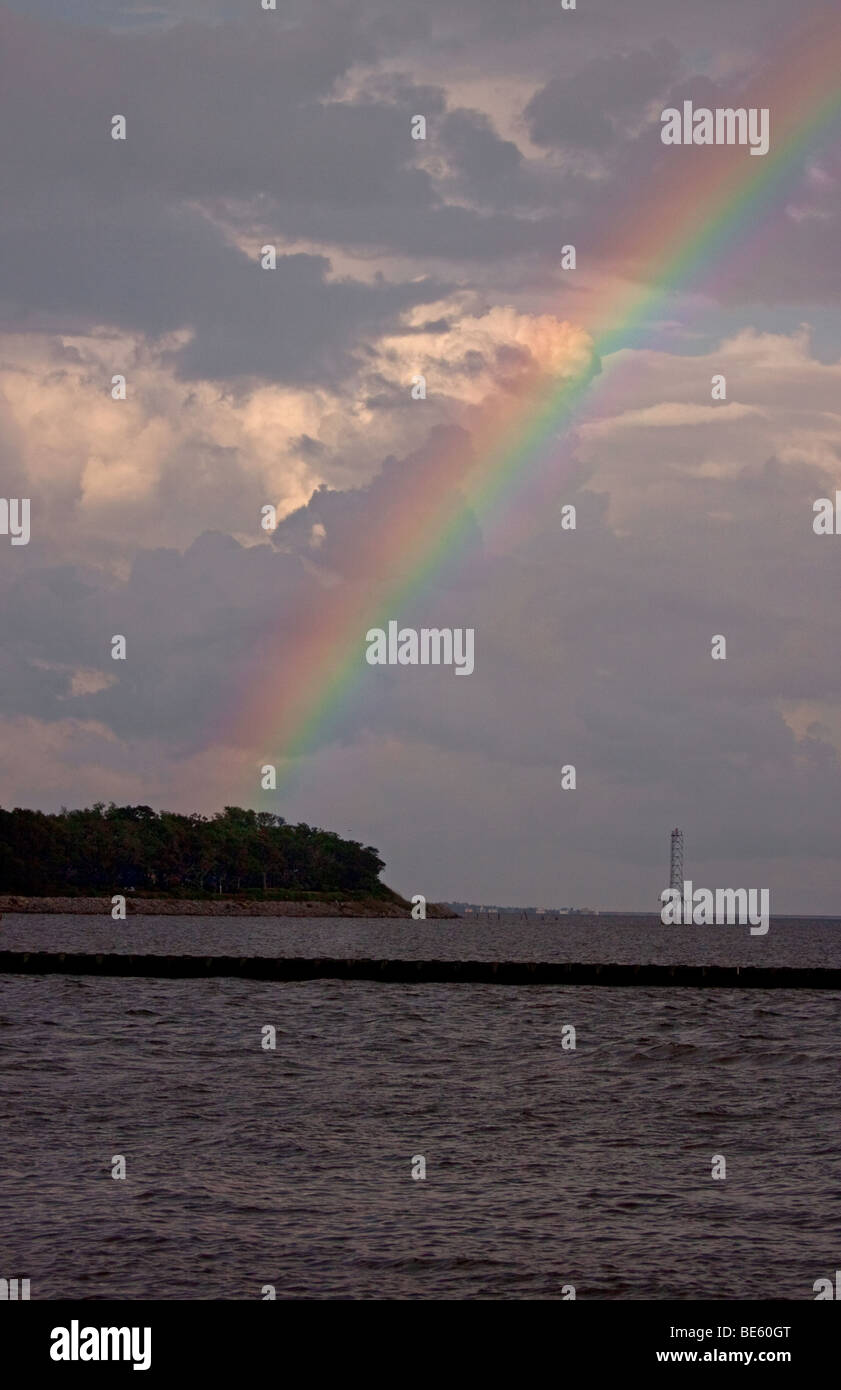 Rainbow over water Stock Photo - Alamy
