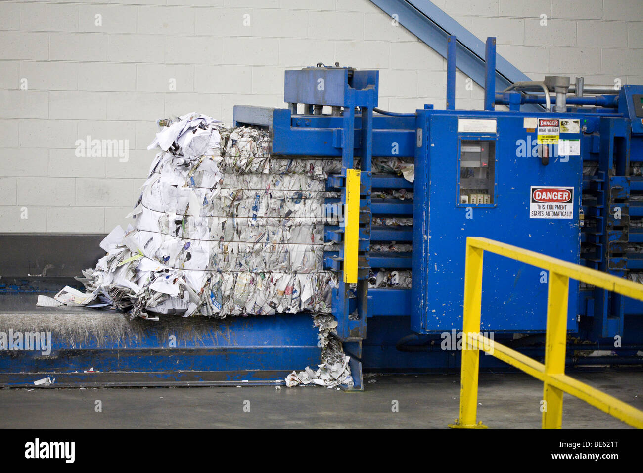 Yesterday's Paper: Waste Paper Bailer. A large machine compresses and ...