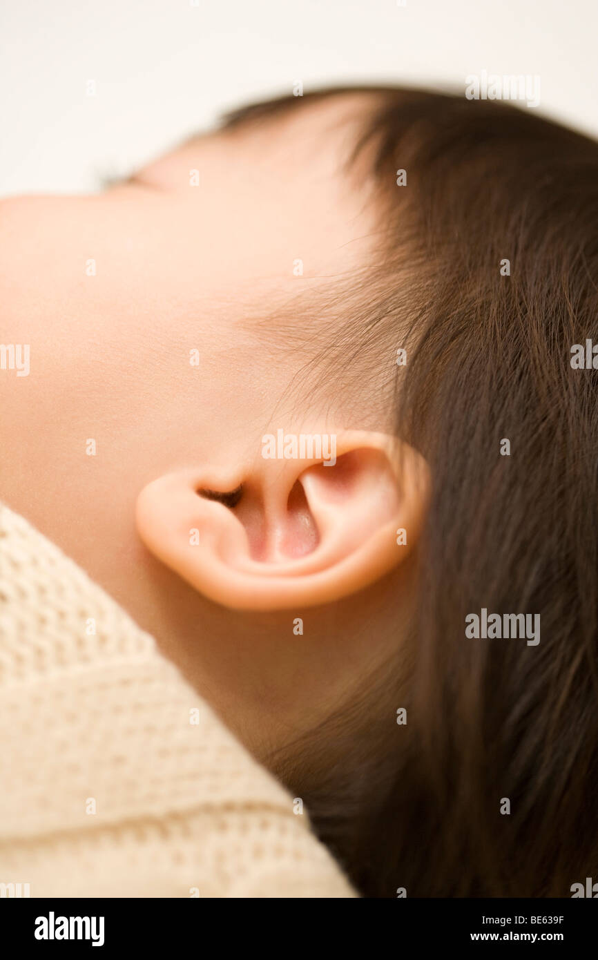 Baby girl's ear Stock Photo - Alamy