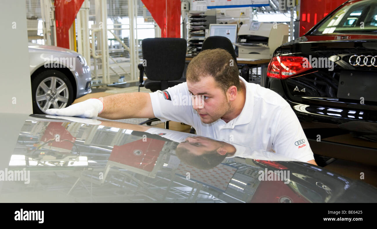 An Audi employee is checking an Audi A4 sedan for possible faults at ...