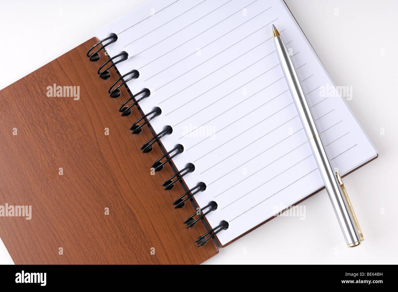 Open notepad with a pen Stock Photo - Alamy