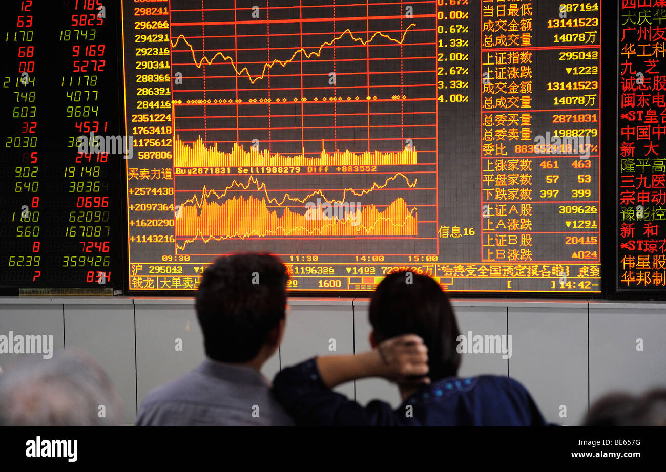 Investors look at stock index screen at a stock securities company in ...