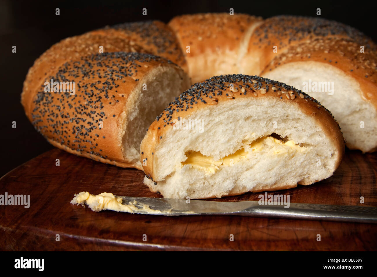 Fancy, seed bread loaf with buttered portion Stock Photo - Alamy