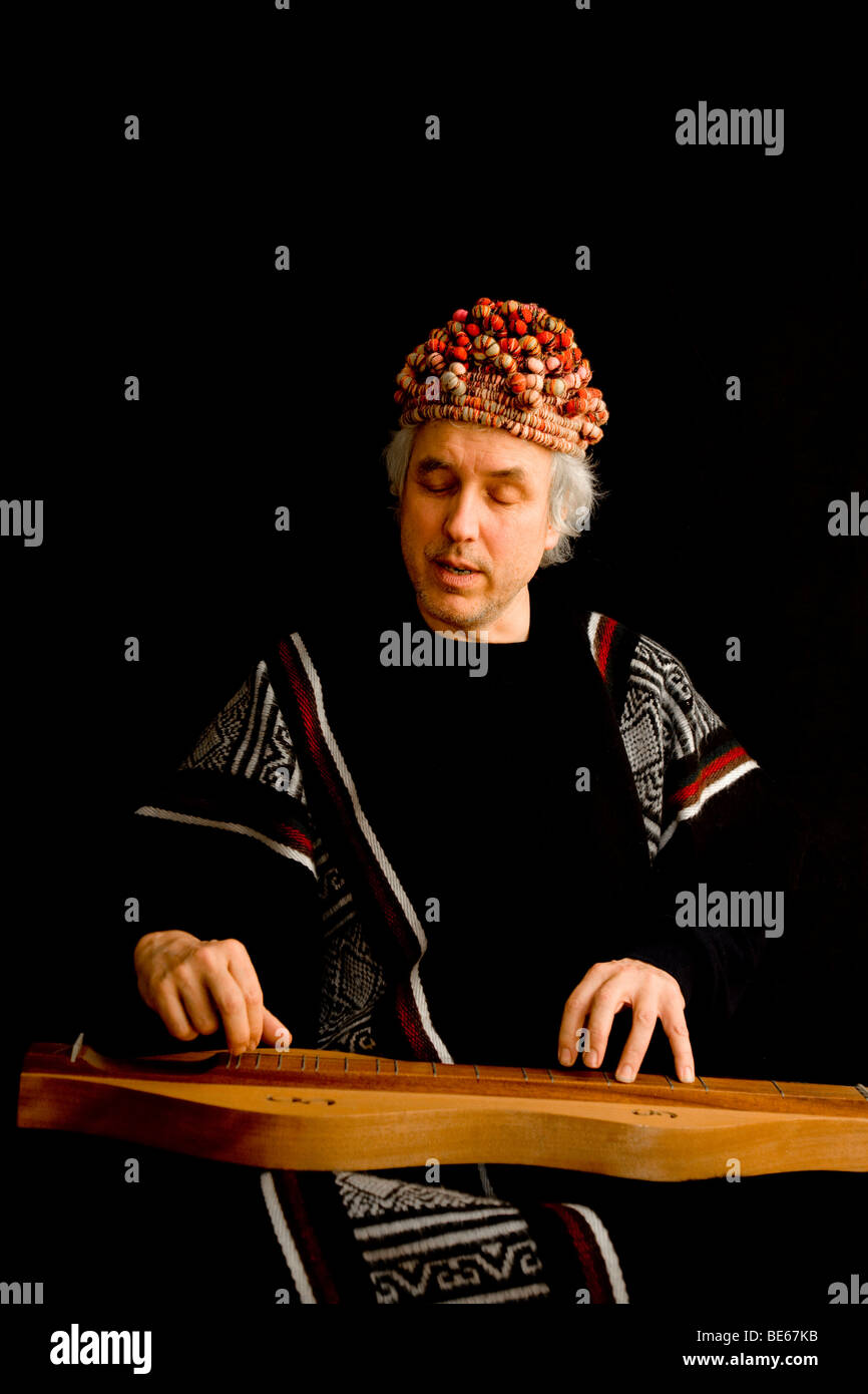 Musician in traditional costume playing the dulcimer Stock Photo - Alamy