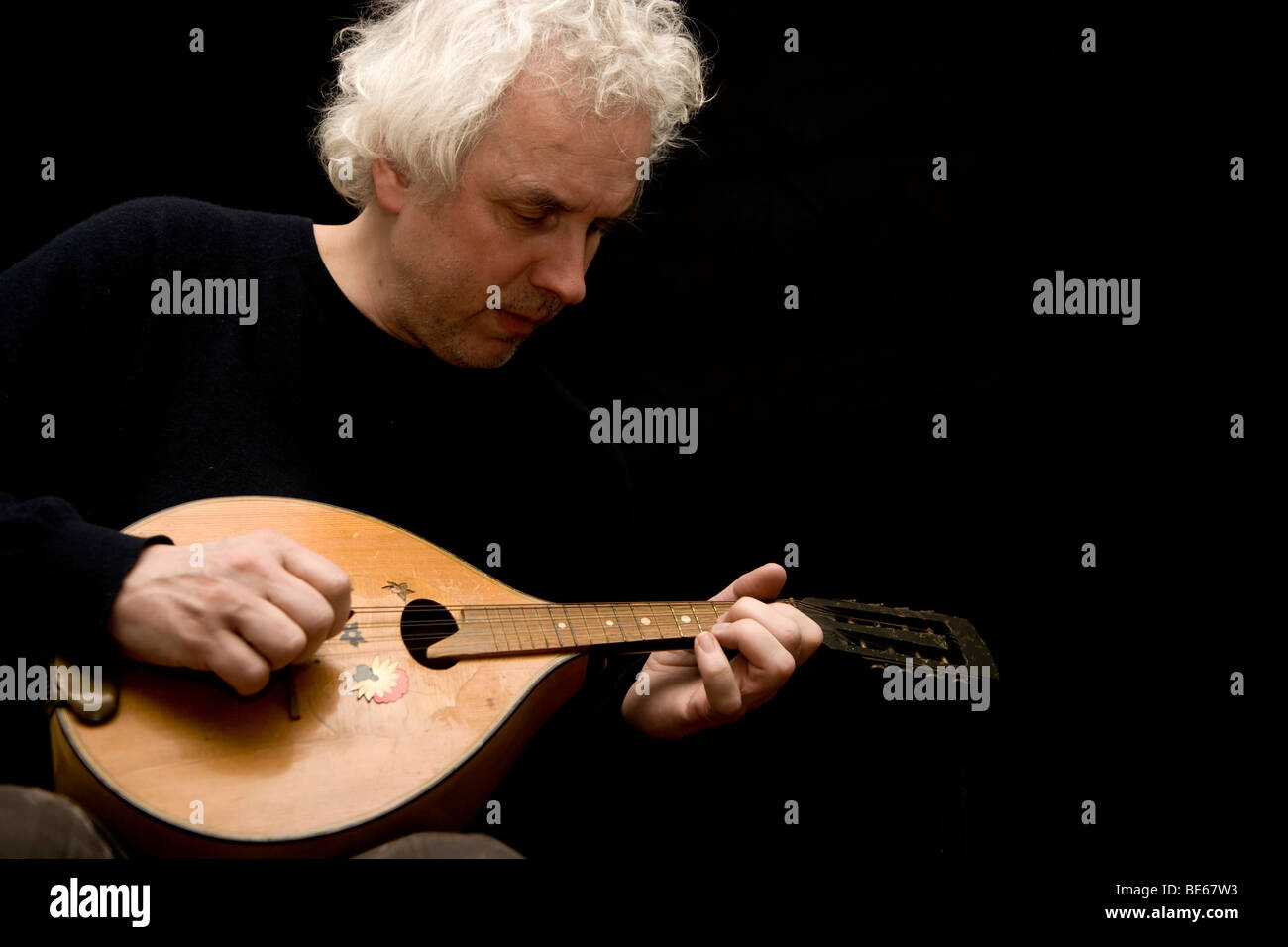 Musician playing a mandolin Stock Photo - Alamy