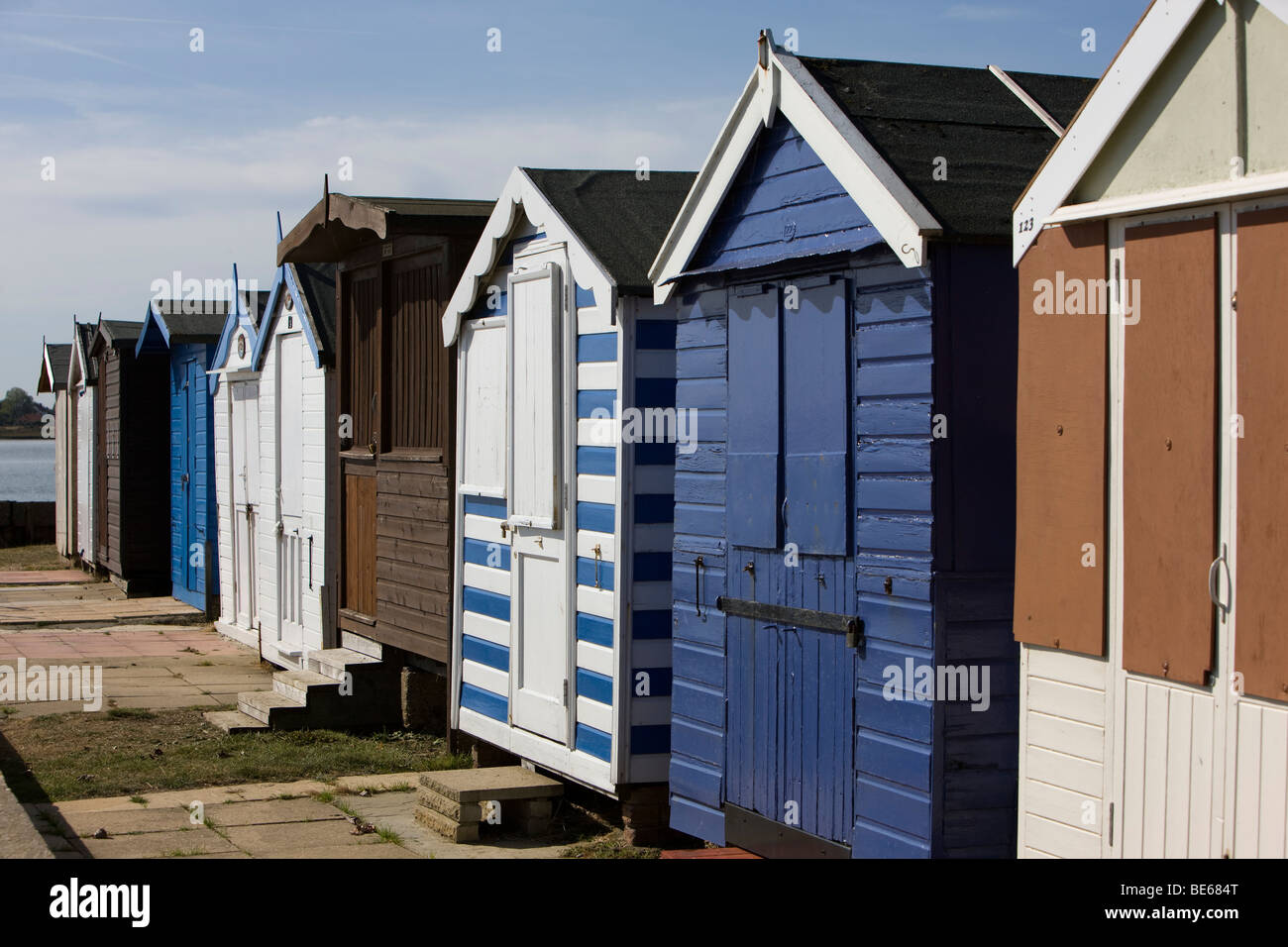 Brightly painted beach huts on the sea front of the Essex coastal town ...
