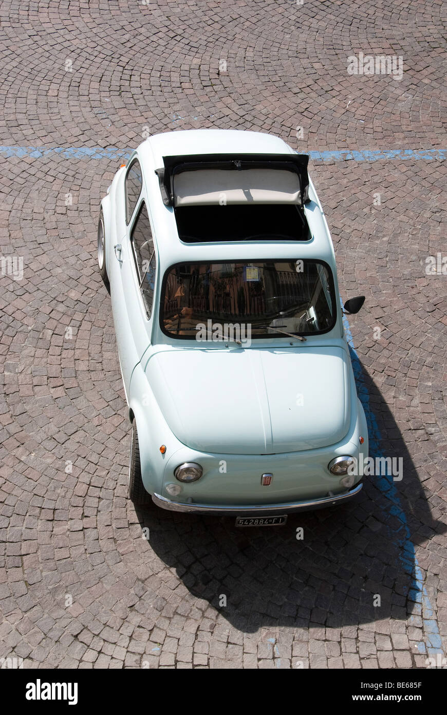 Piazza in Greve in Chianti with powder blue Fiat 500 car seen from ...