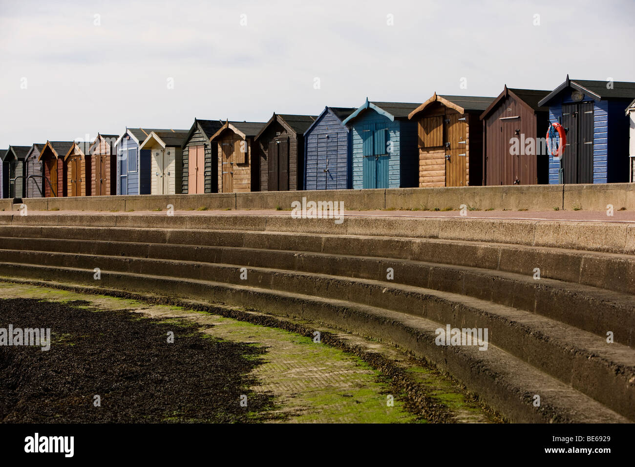 Brightly painted beach huts on the sea front of the Essex coastal town ...
