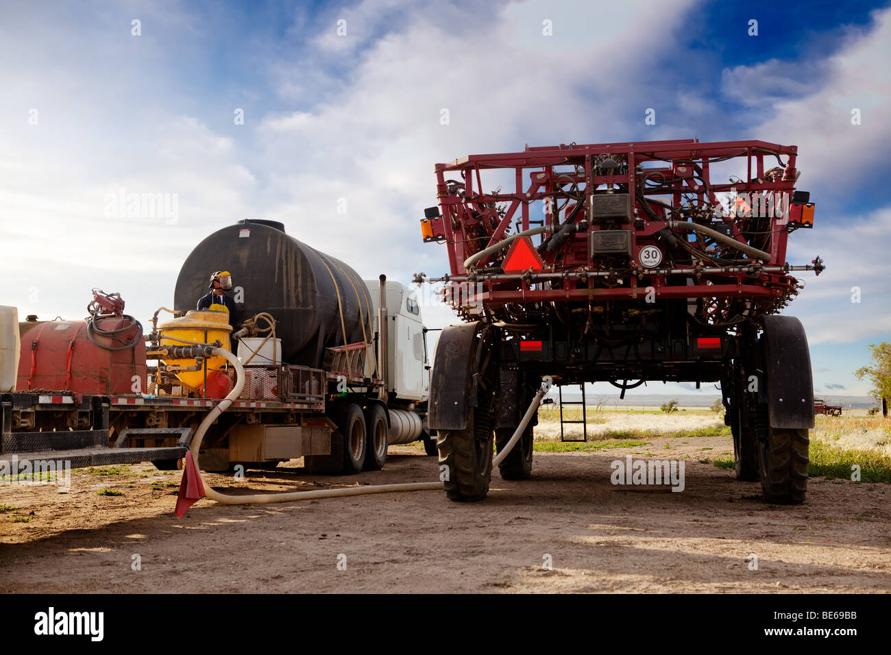A high clearance spraying being filled with chemical and water Stock ...