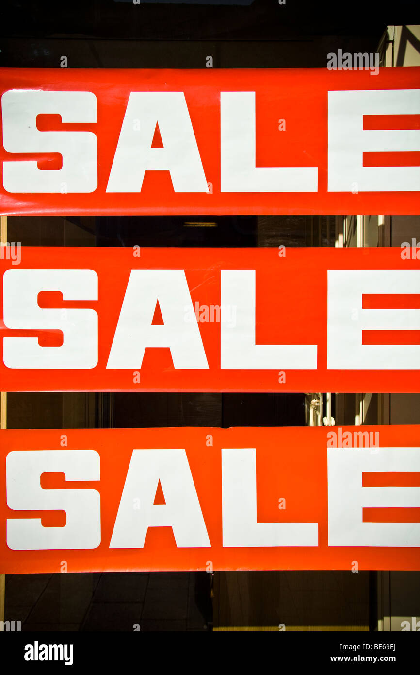 Sale signs in shop window Stock Photo - Alamy