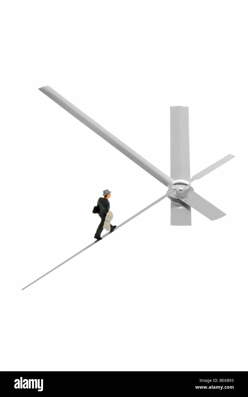 Business man running on second hand of a clock which shows five to ...
