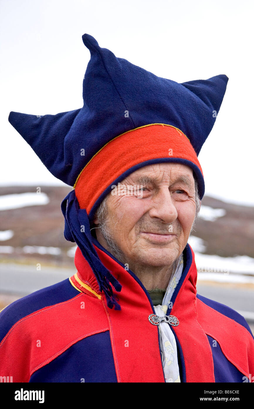 Elderly Sami man in traditional clothing stands by his tent near the ...