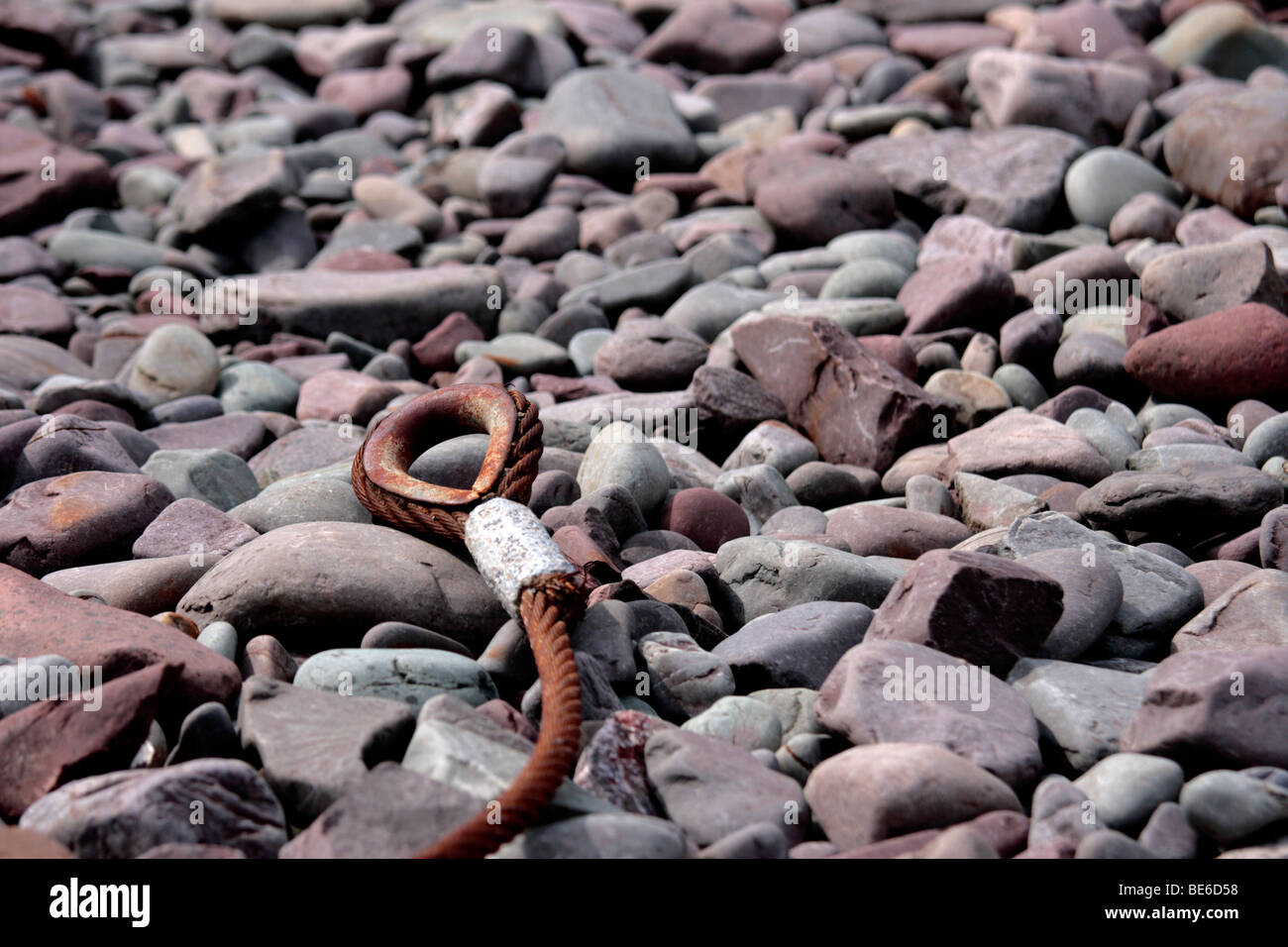 rusty cable on beach stones Stock Photo - Alamy