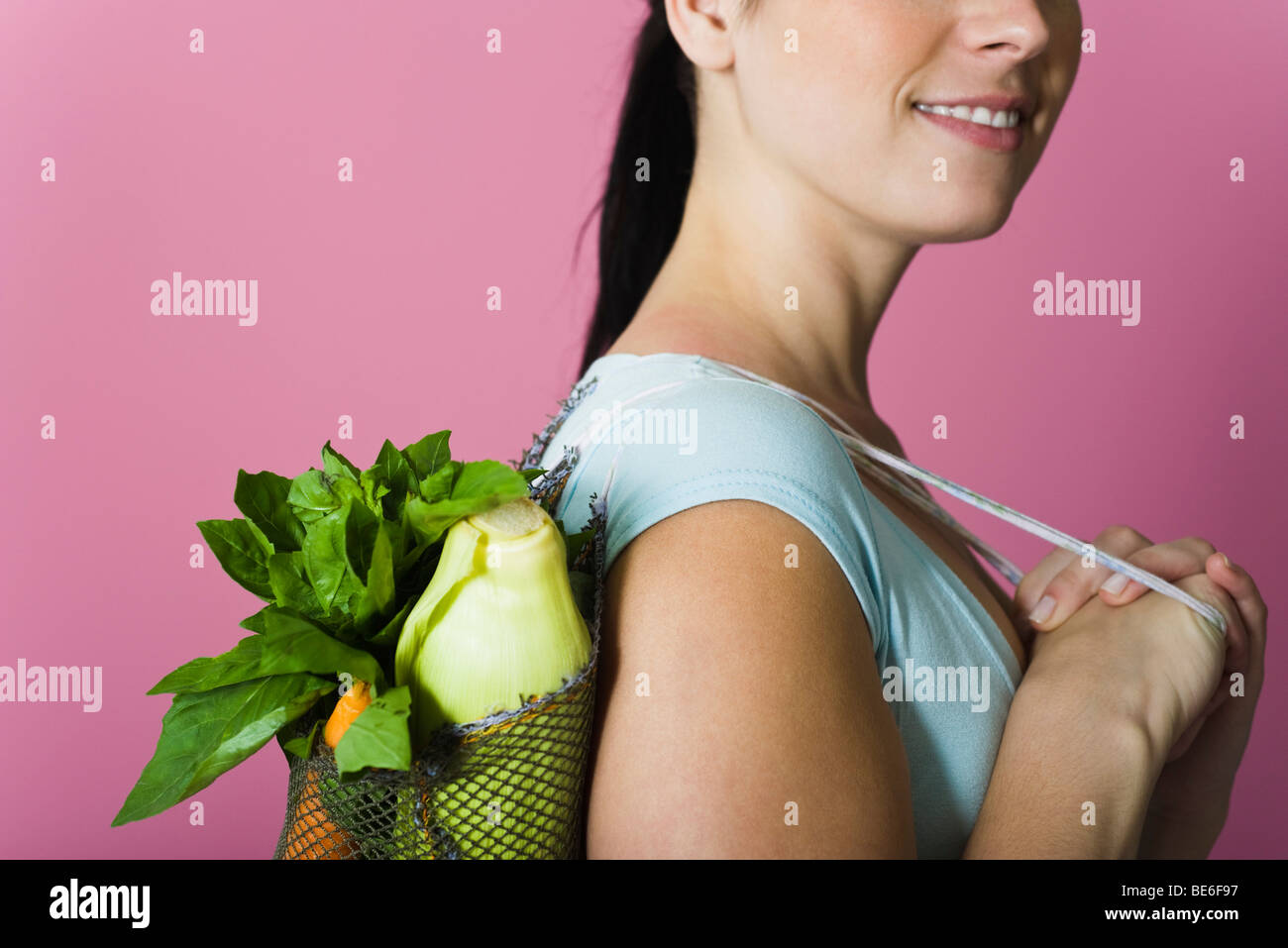 Woman with sack of fresh vegetables carried over shoulder Stock Photo ...