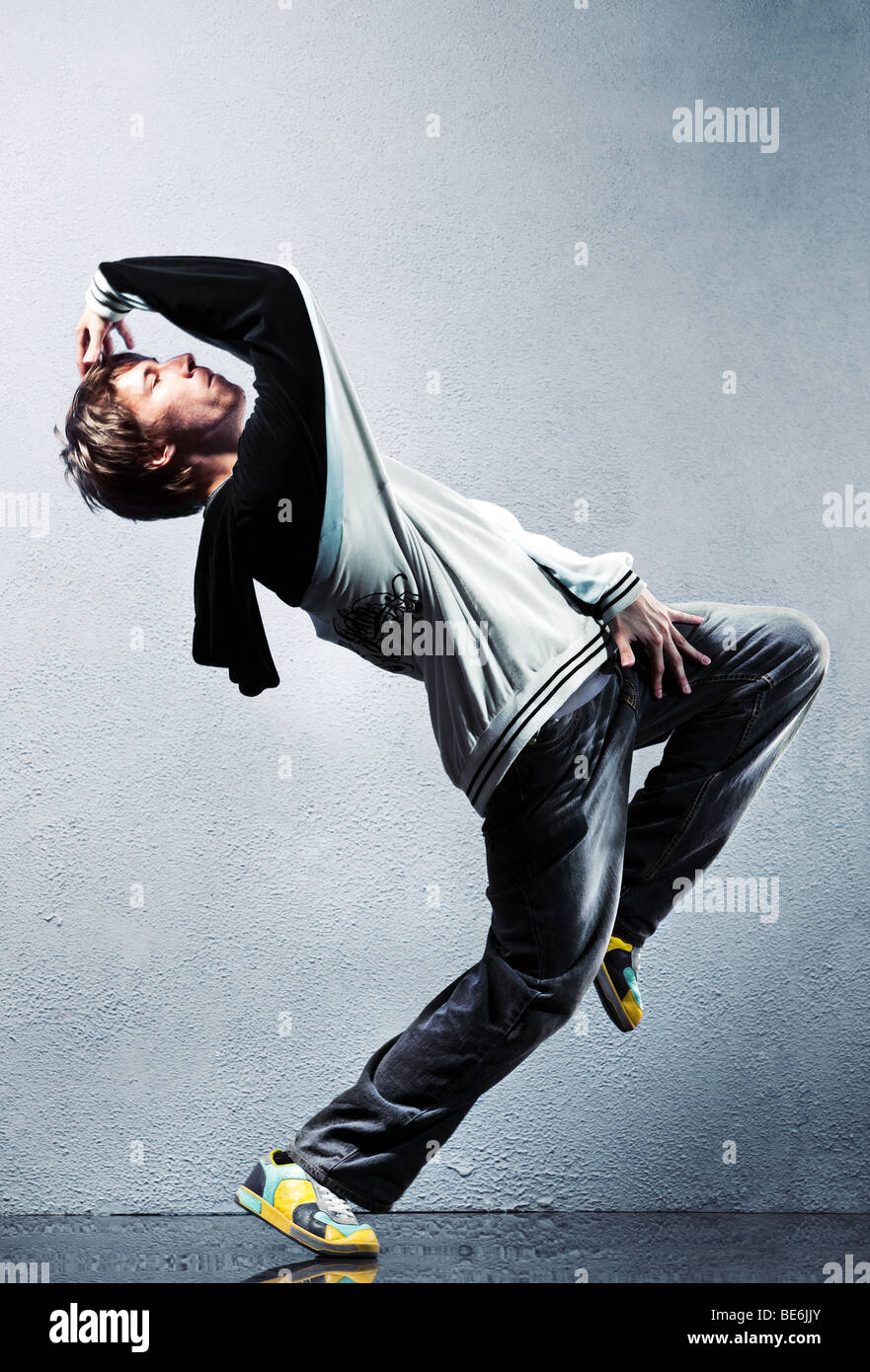Young man modern dance. On wall background Stock Photo - Alamy