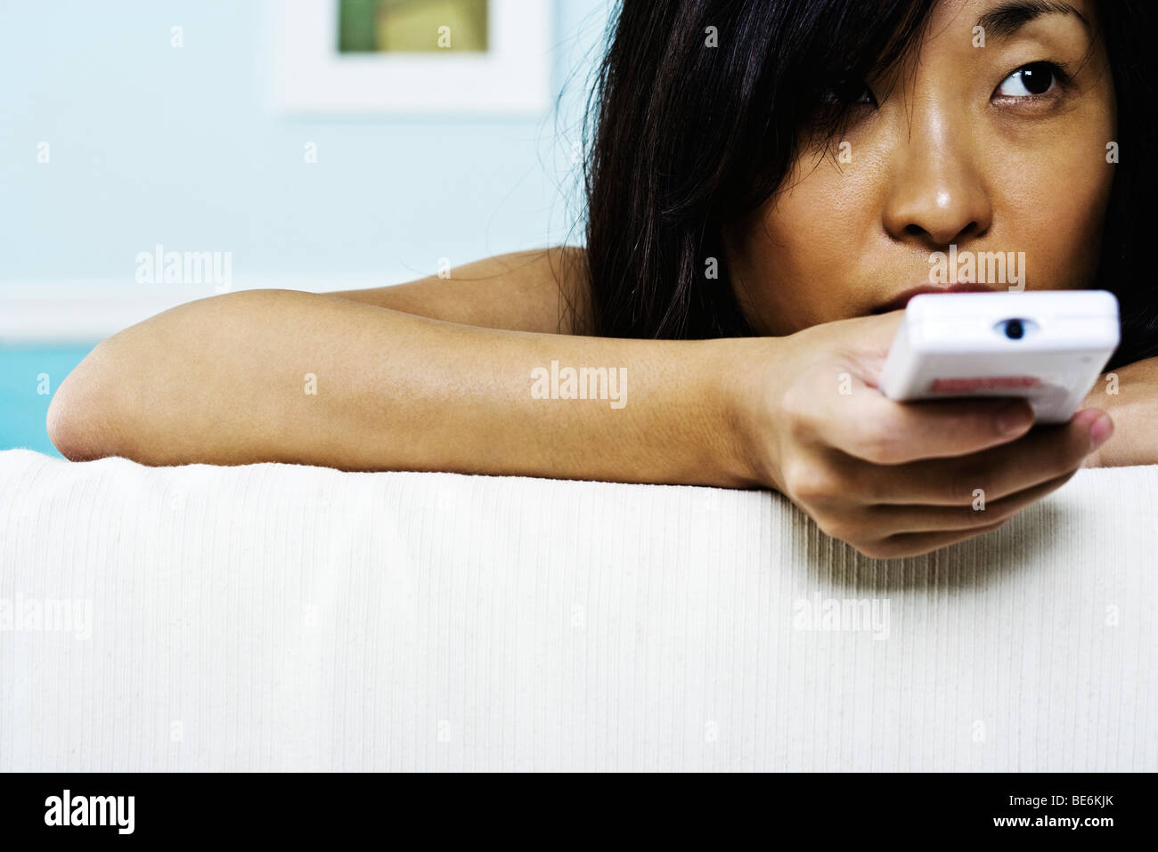 Woman using remote control Stock Photo - Alamy