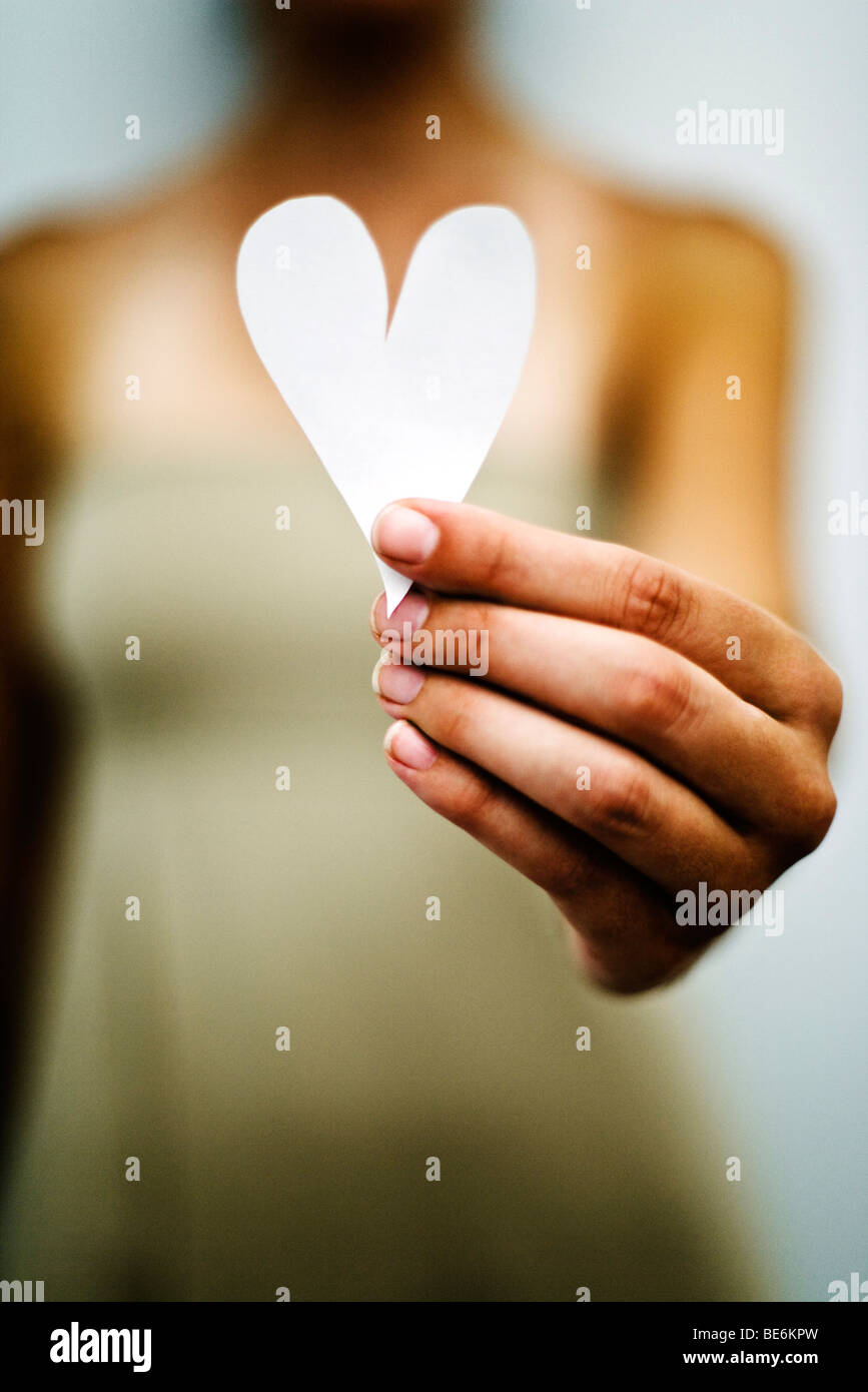 Woman's hand holding out paper heart Stock Photo - Alamy