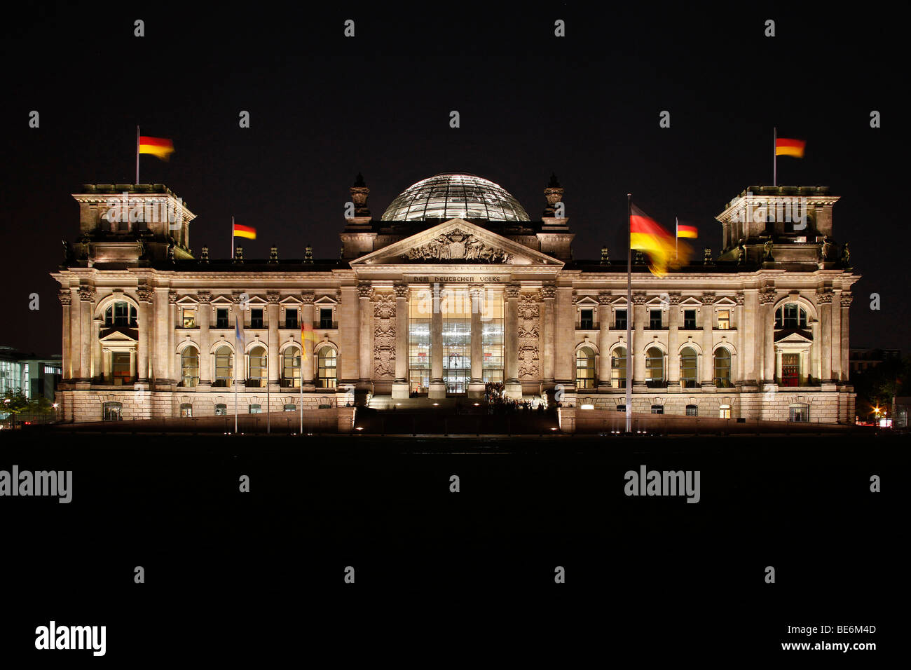 German Reichstag building with dome and flag at night, Berlin, Germany ...
