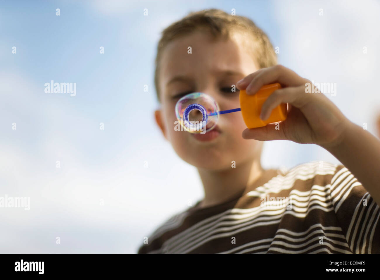 Little boy blowing bubble with bubble wand Stock Photo - Alamy