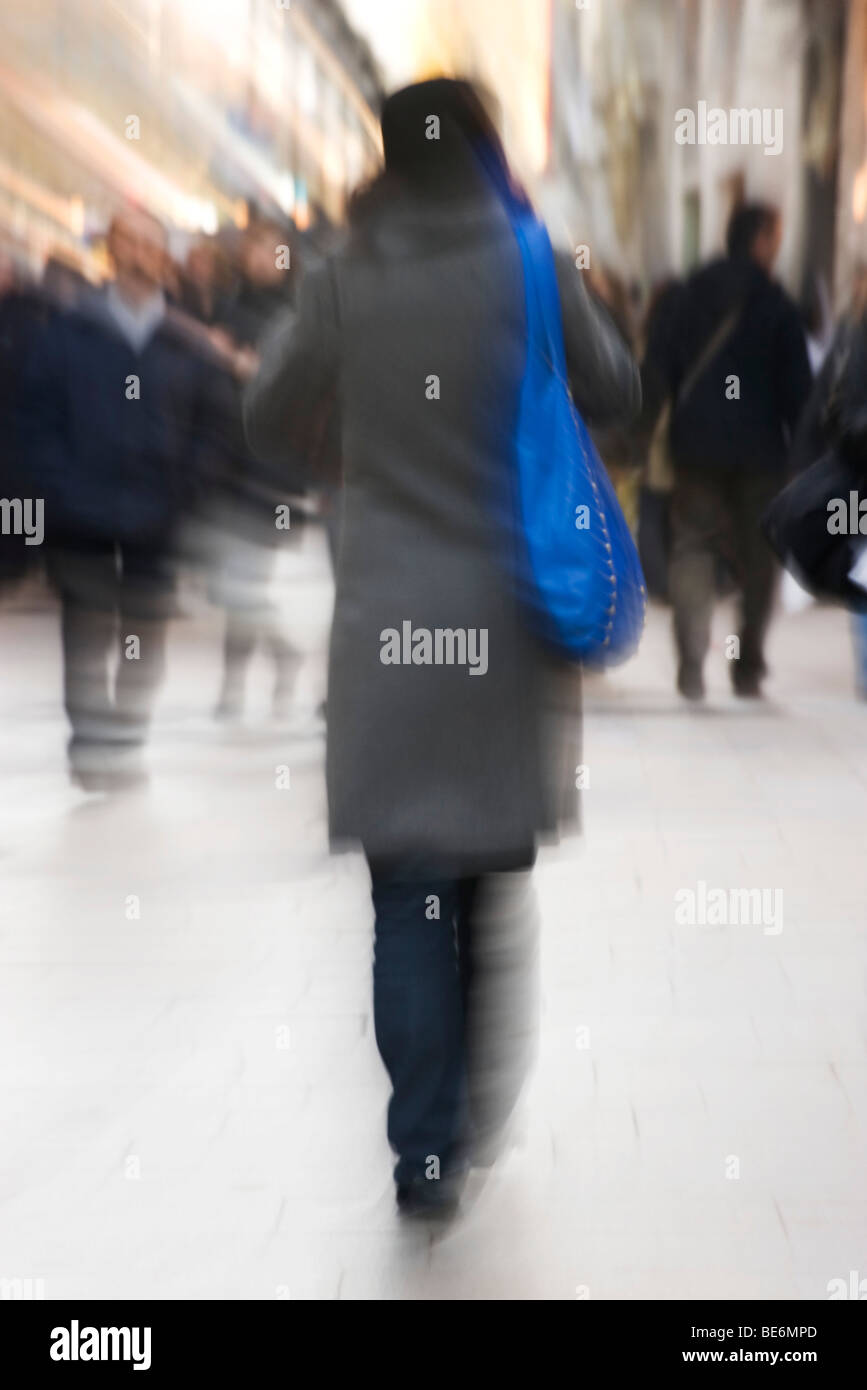 Pedestrians walking on sidewalk, rear view, blurred Stock Photo - Alamy