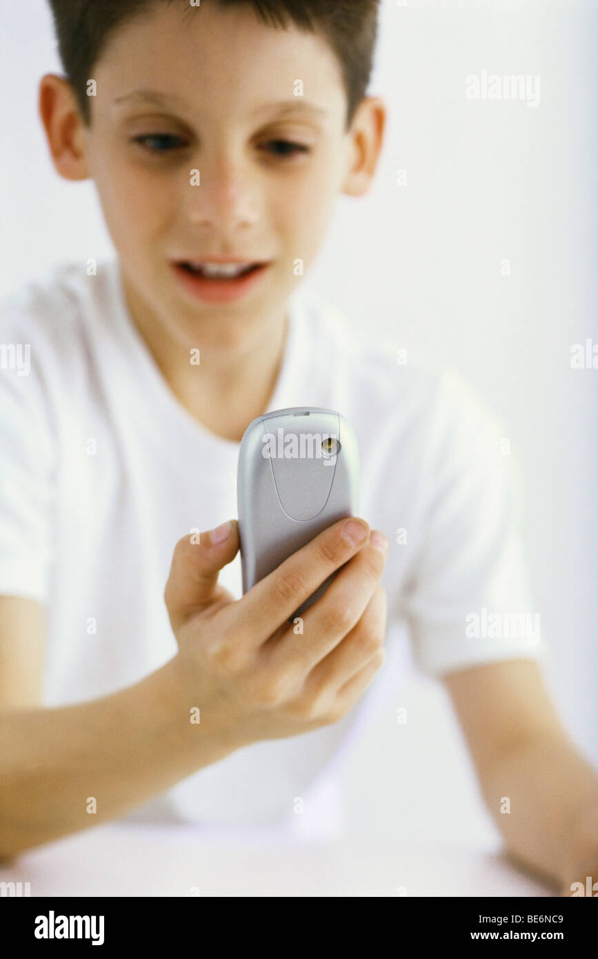 Boy looking at cell phone Stock Photo - Alamy