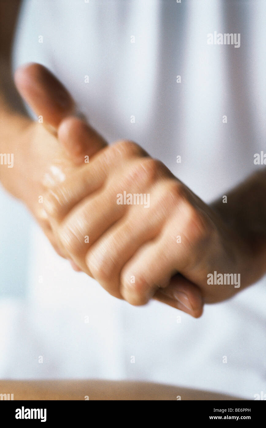 Massage therapist rubbing hands together, cropped Stock Photo - Alamy