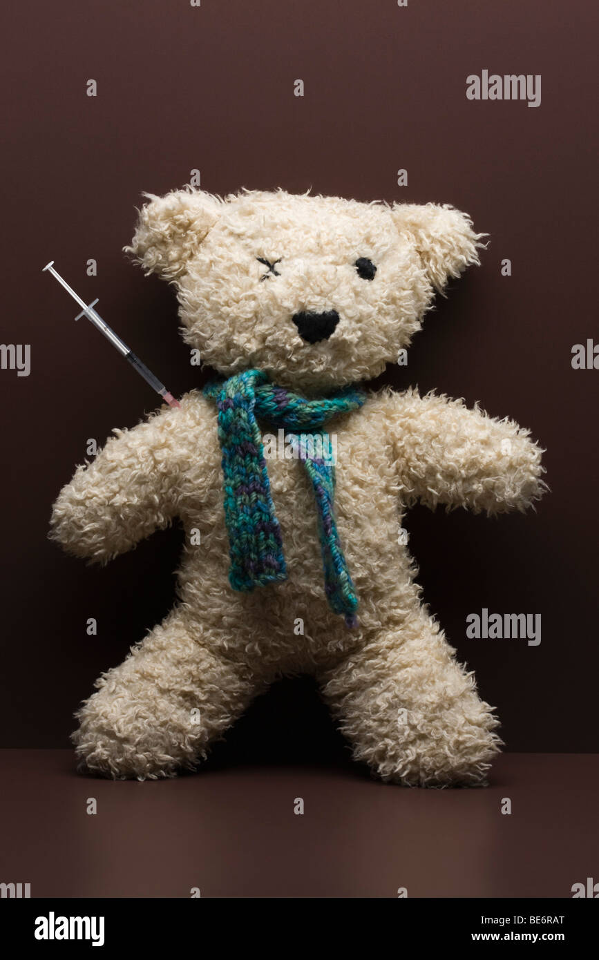 Syringe sticking out of teddy bear Stock Photo - Alamy