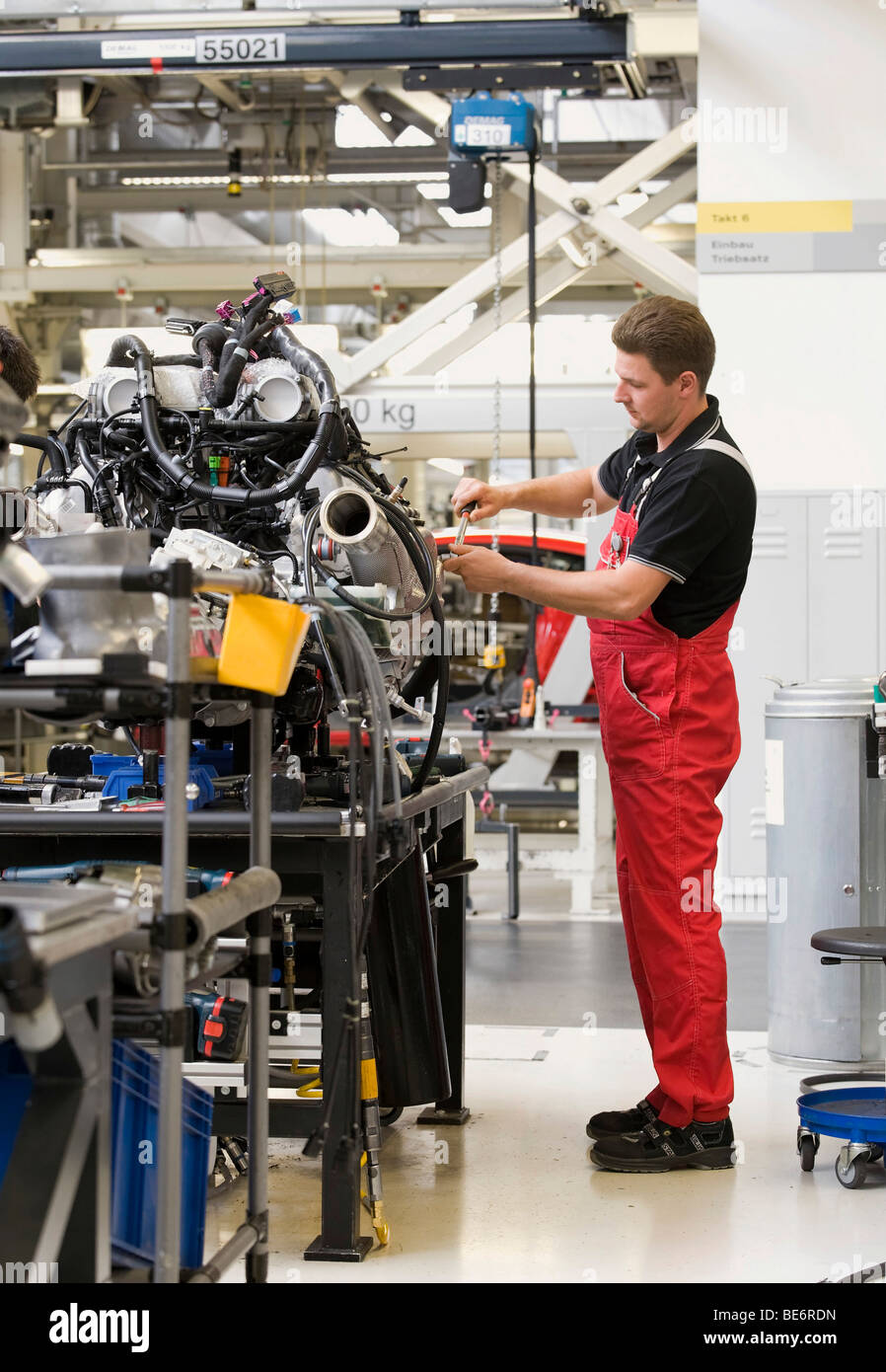 Audi employee assembling the drive unit of an Audi R8 sports car in the ...