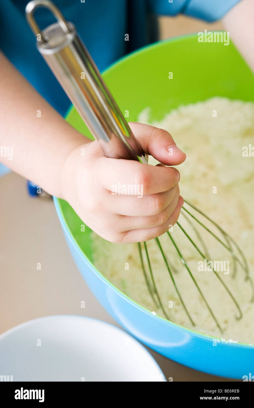 Child stirring batter with whisk, cropped view Stock Photo - Alamy