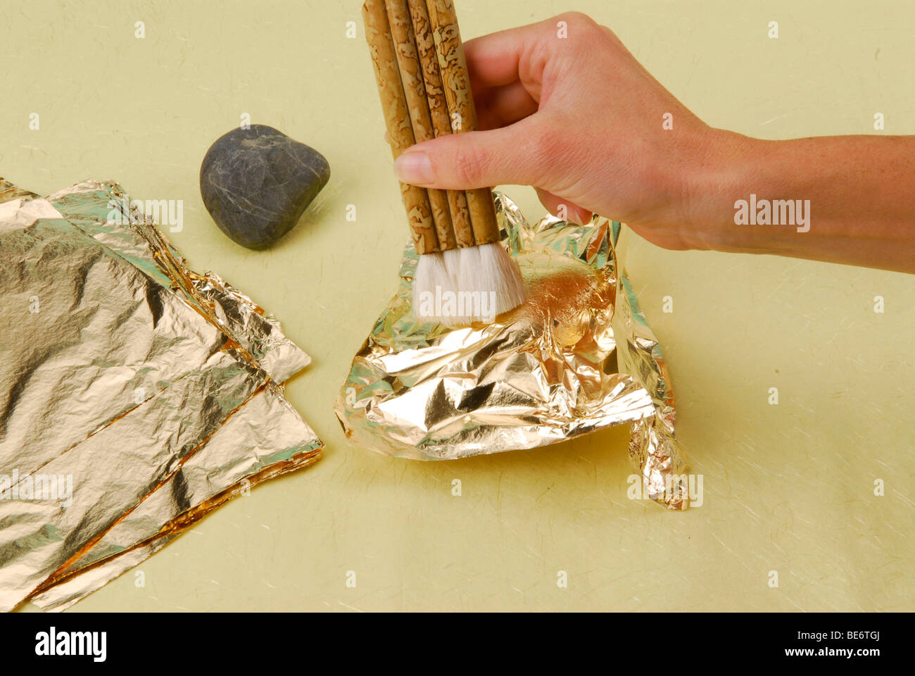 Gilding with gold leaf and gilding brush Stock Photo - Alamy