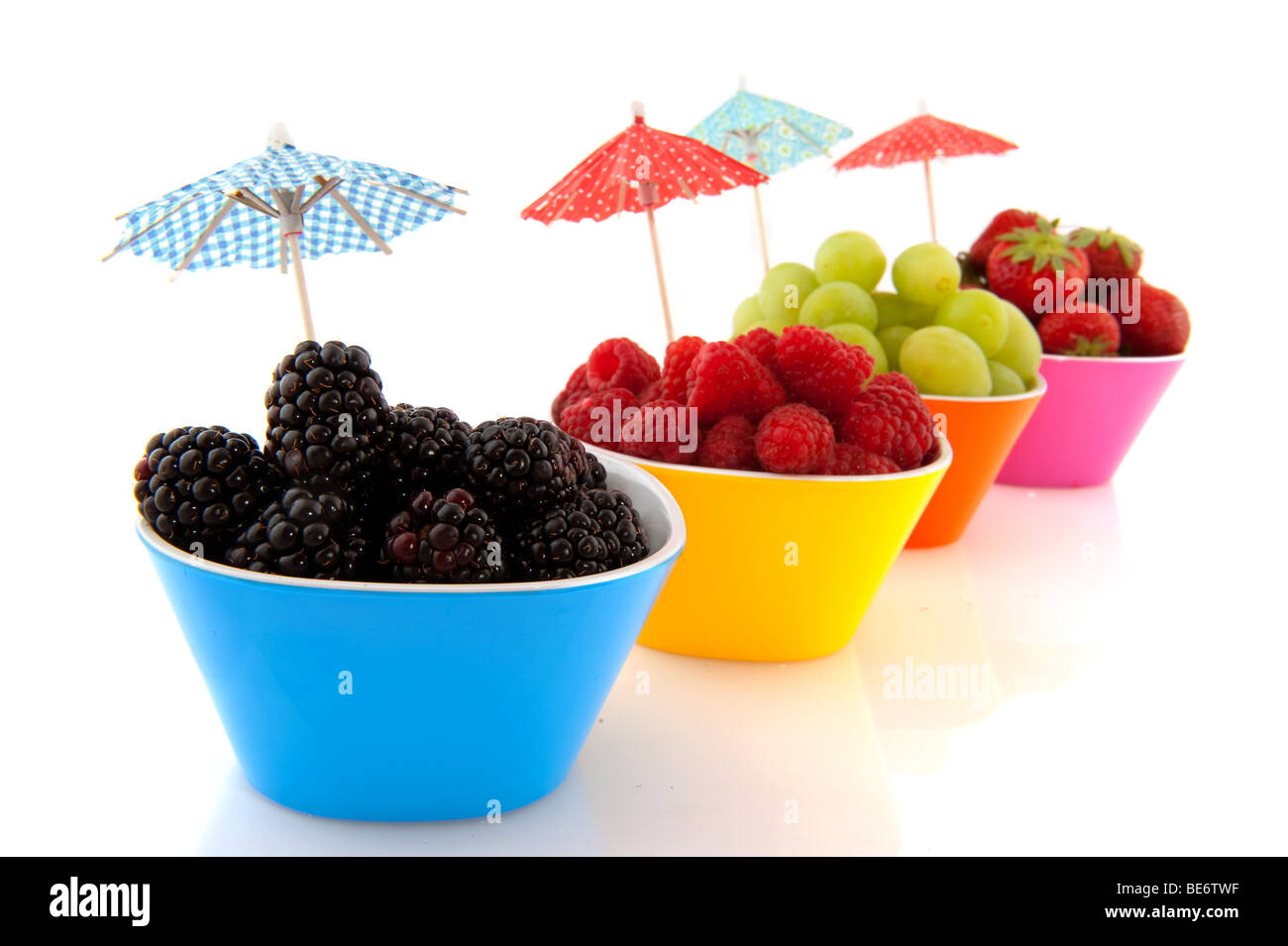 fresh summer fruit in colorful bowls with cheerful parasols Stock Photo ...