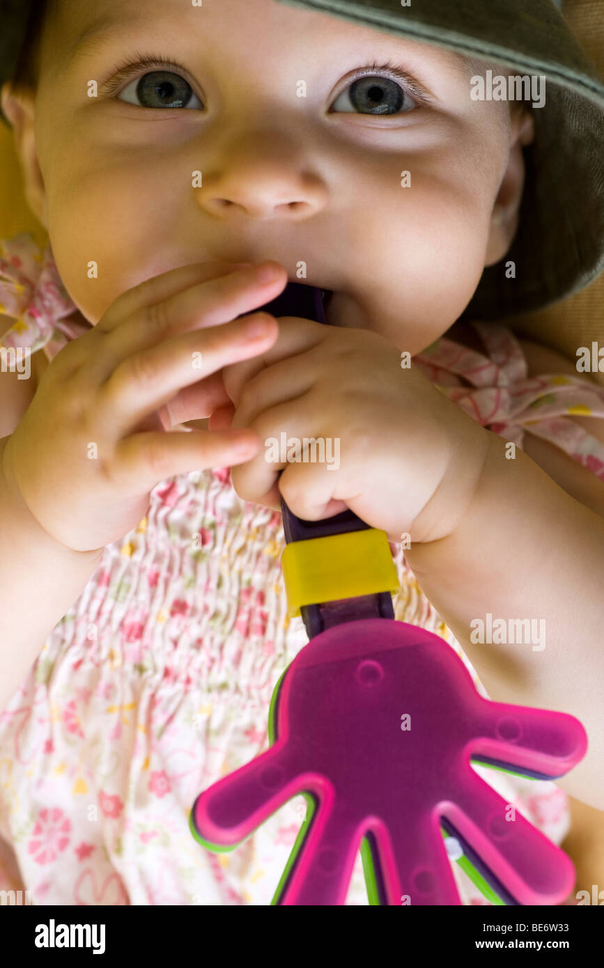Infant chewing on plastic toy Stock Photo - Alamy