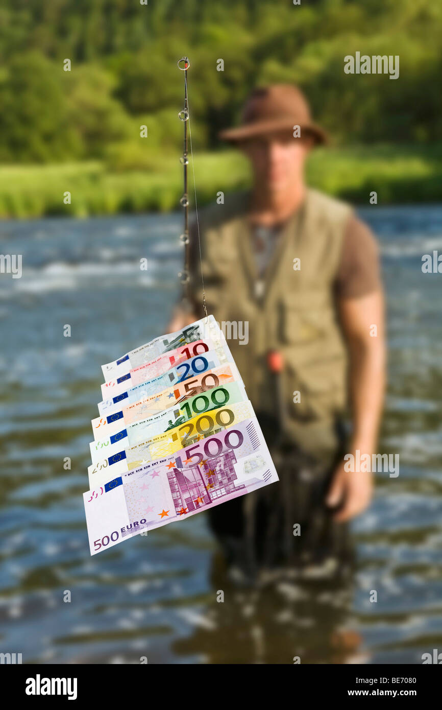 Money on a fishing rod Stock Photo - Alamy