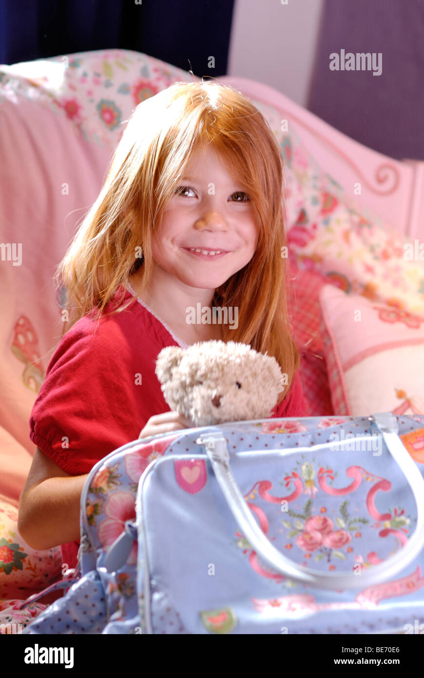 Little girl playing with her teddy bear Stock Photo - Alamy