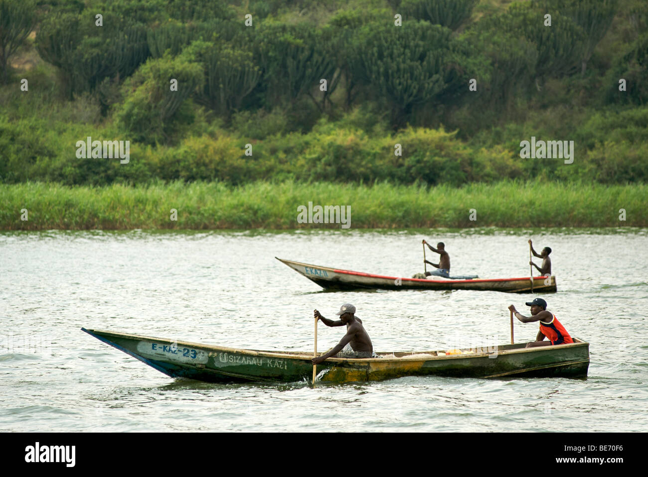 Ugandans in fishing boats on the Kazinga channel that leads between ...