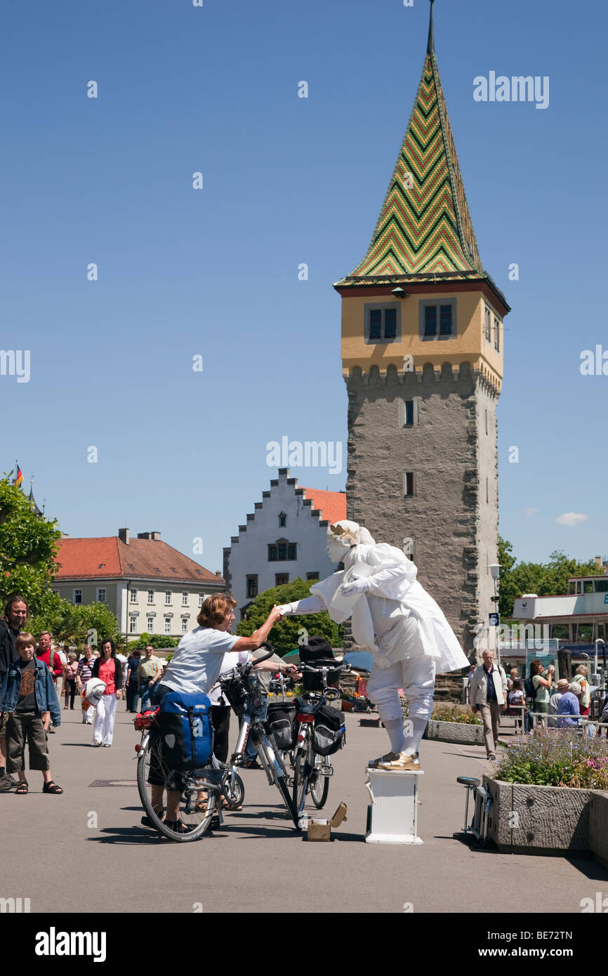 Lindau, Bavaria, Germany. Living statue mime artist greeting tourist on ...