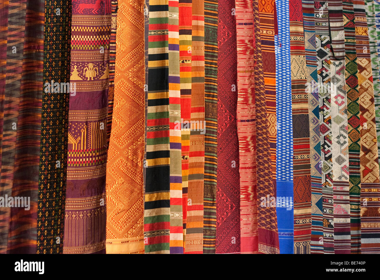 A variety of multi-coloured asian sarongs in the marketplace at Paksein ...