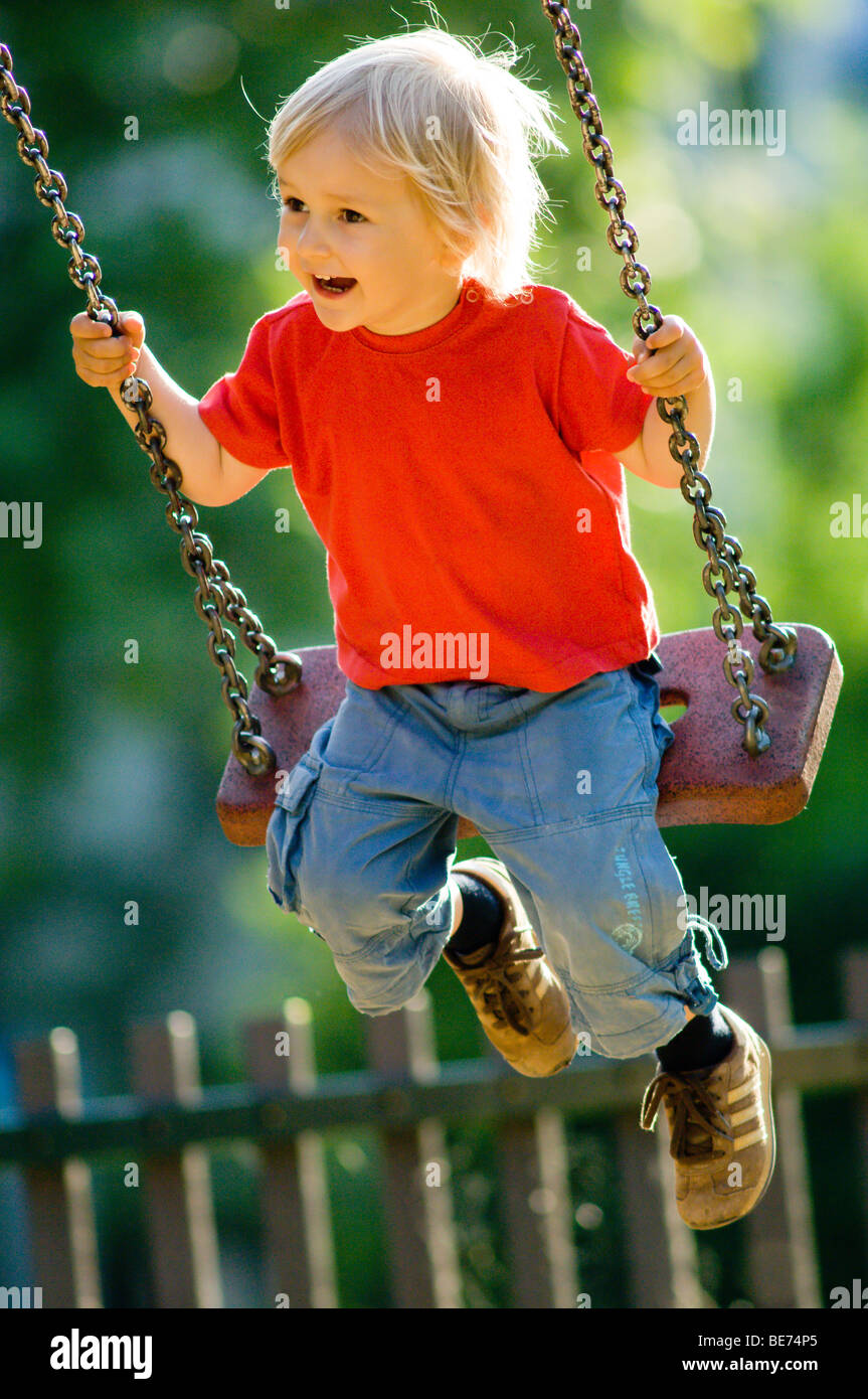 Little boy on the swing Stock Photo - Alamy