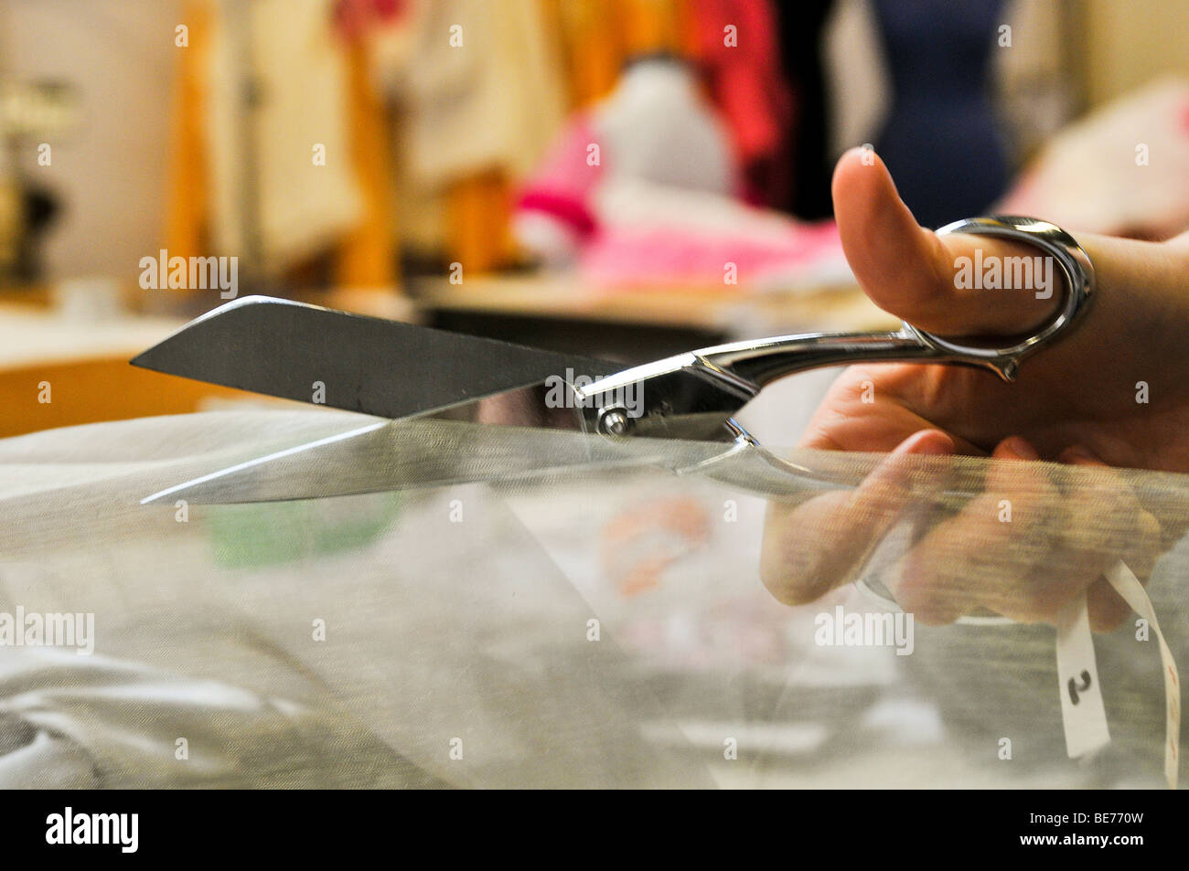 Scissors cutting a piece of cloth Stock Photo - Alamy
