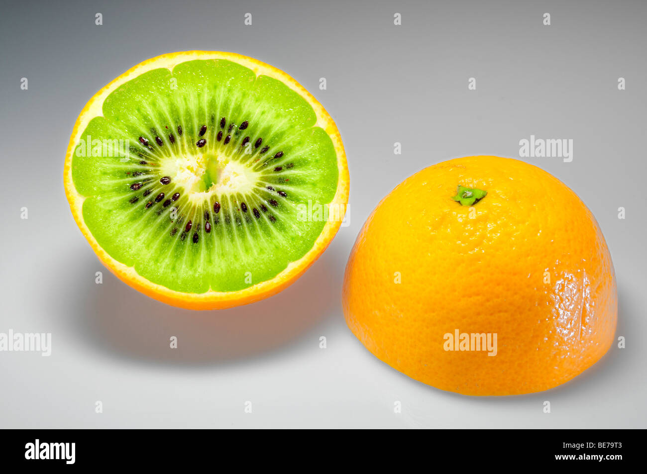 Orange filled with a Kiwi, symbolic image for genetic engineering Stock ...