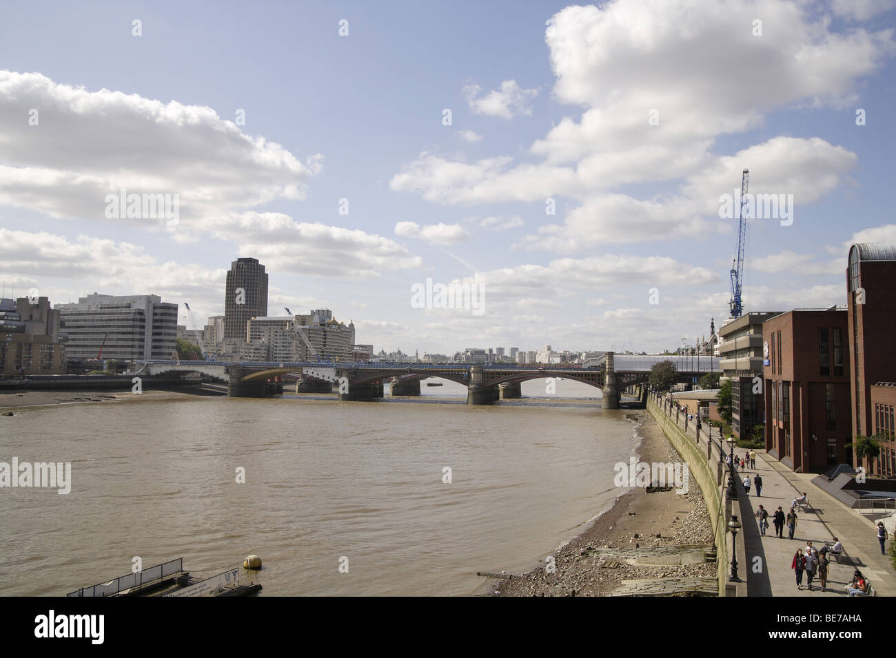 River thames people enjoying low tide sand bankside in the summer ...