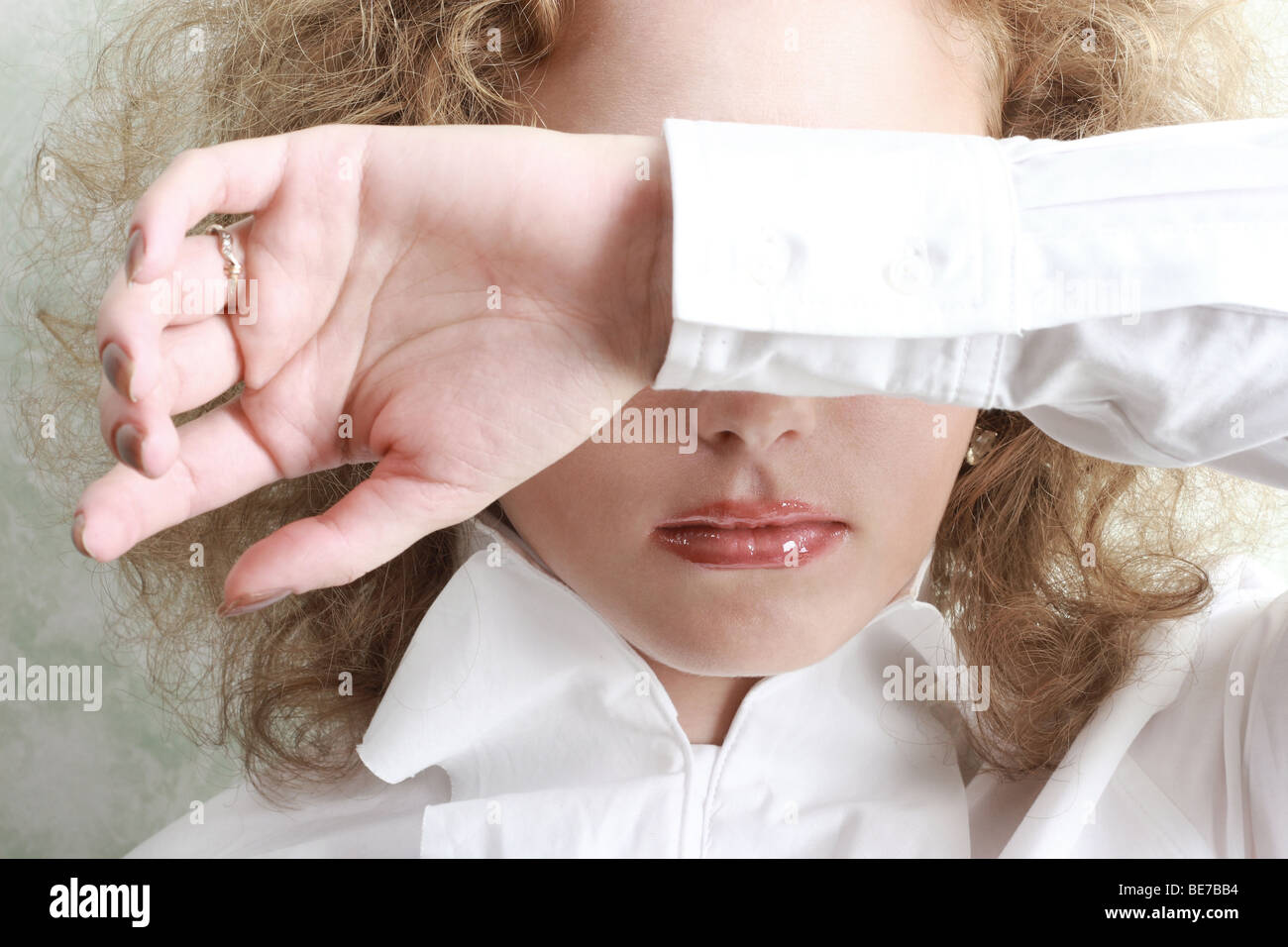 Young woman covering her eyes Stock Photo - Alamy