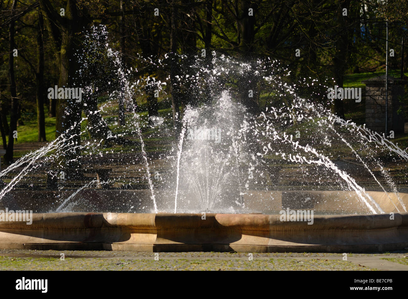 Fountain with running water and pavement Stock Photo - Alamy